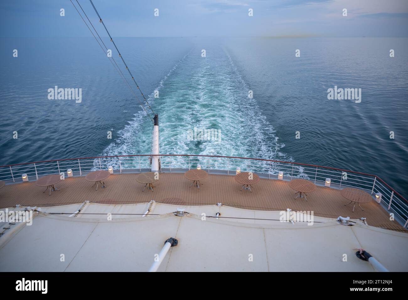 Backside of a cruise ship, sea during sunset, boat deck with waves ...