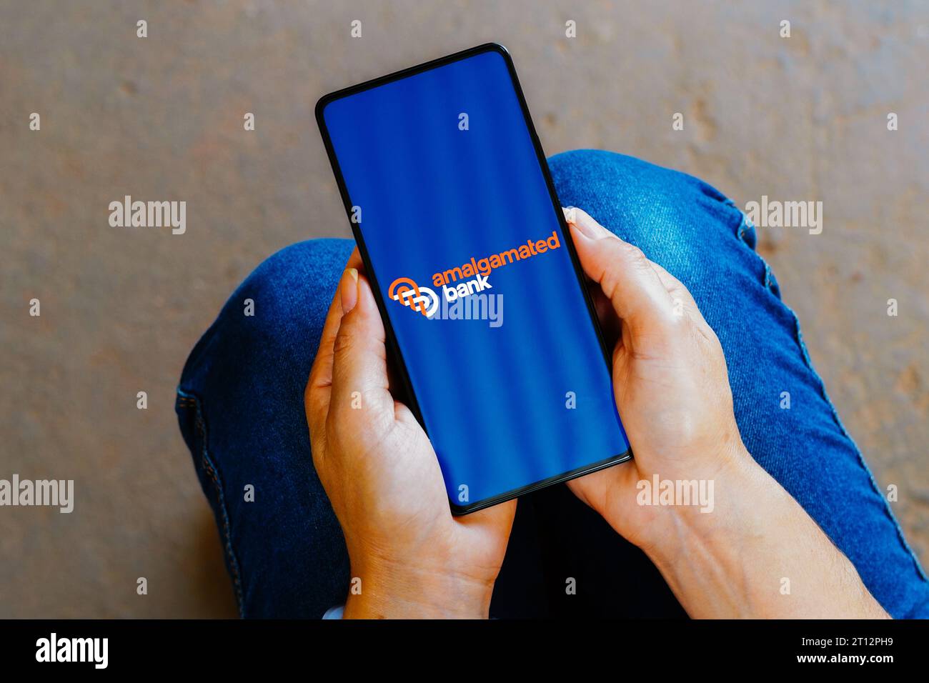 In this photo illustration, the Amalgamated Bank logo is displayed on a ...