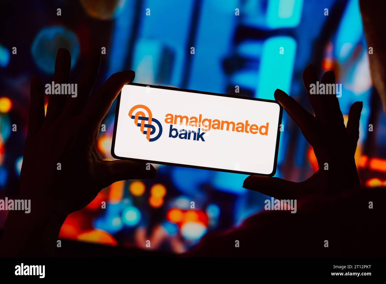 In this photo illustration, the Amalgamated Bank logo is displayed on a ...