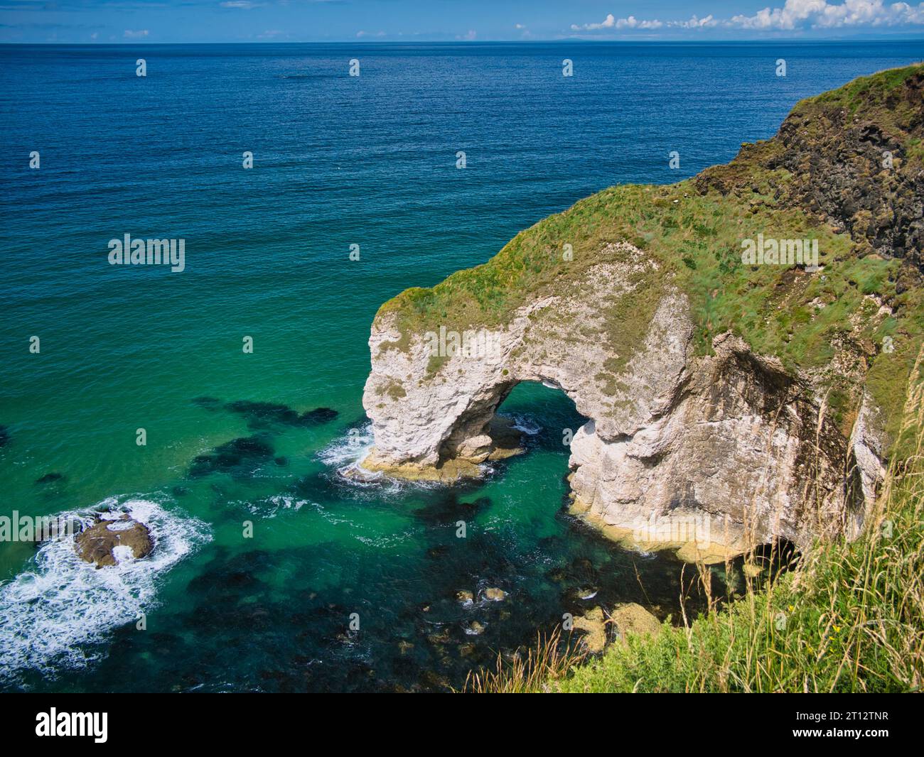 The natural arch known as The Wishing Arch on the Antrim Coast, near ...