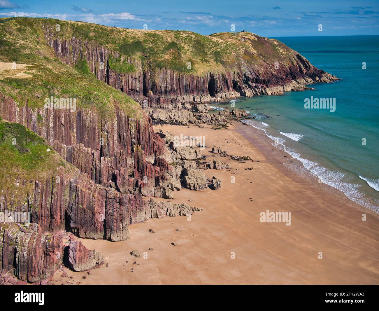 Coastal red cliffs near Manorbier in Pembrokeshire, Wales, UK - the ...