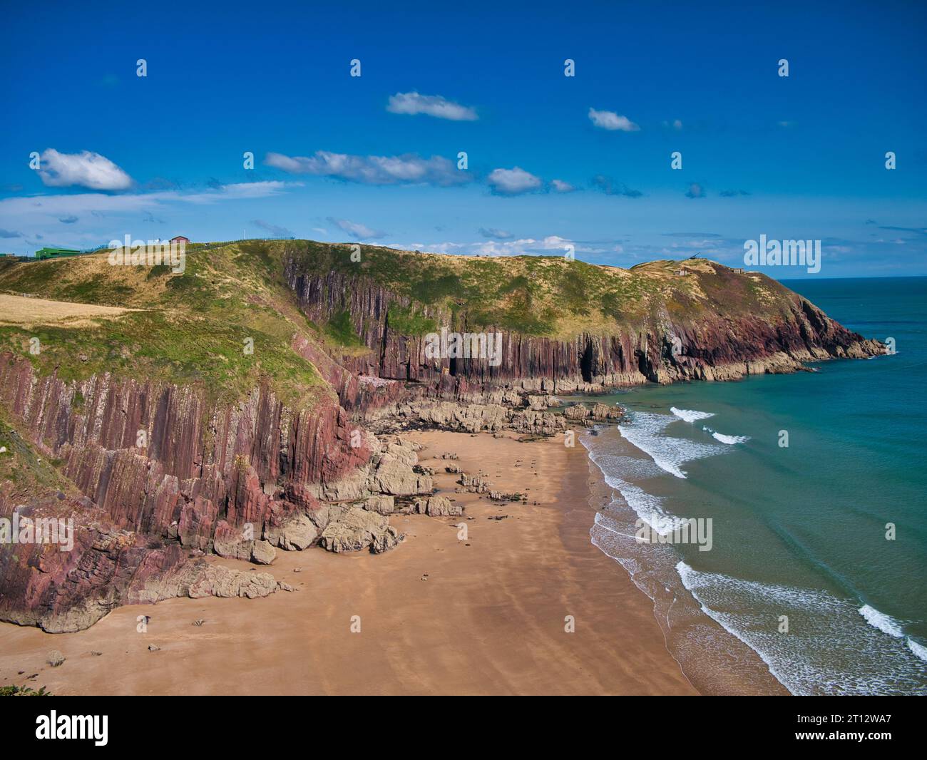 Coastal red cliffs near Manorbier in Pembrokeshire, Wales, UK - the ...