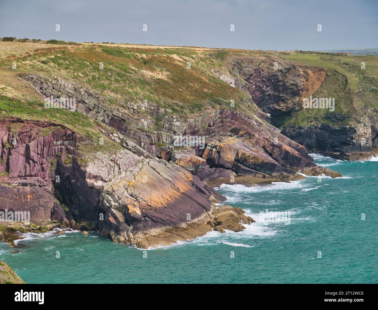 Coastal red cliffs near Solva in Pembrokeshire, Wales, UK - steeply ...