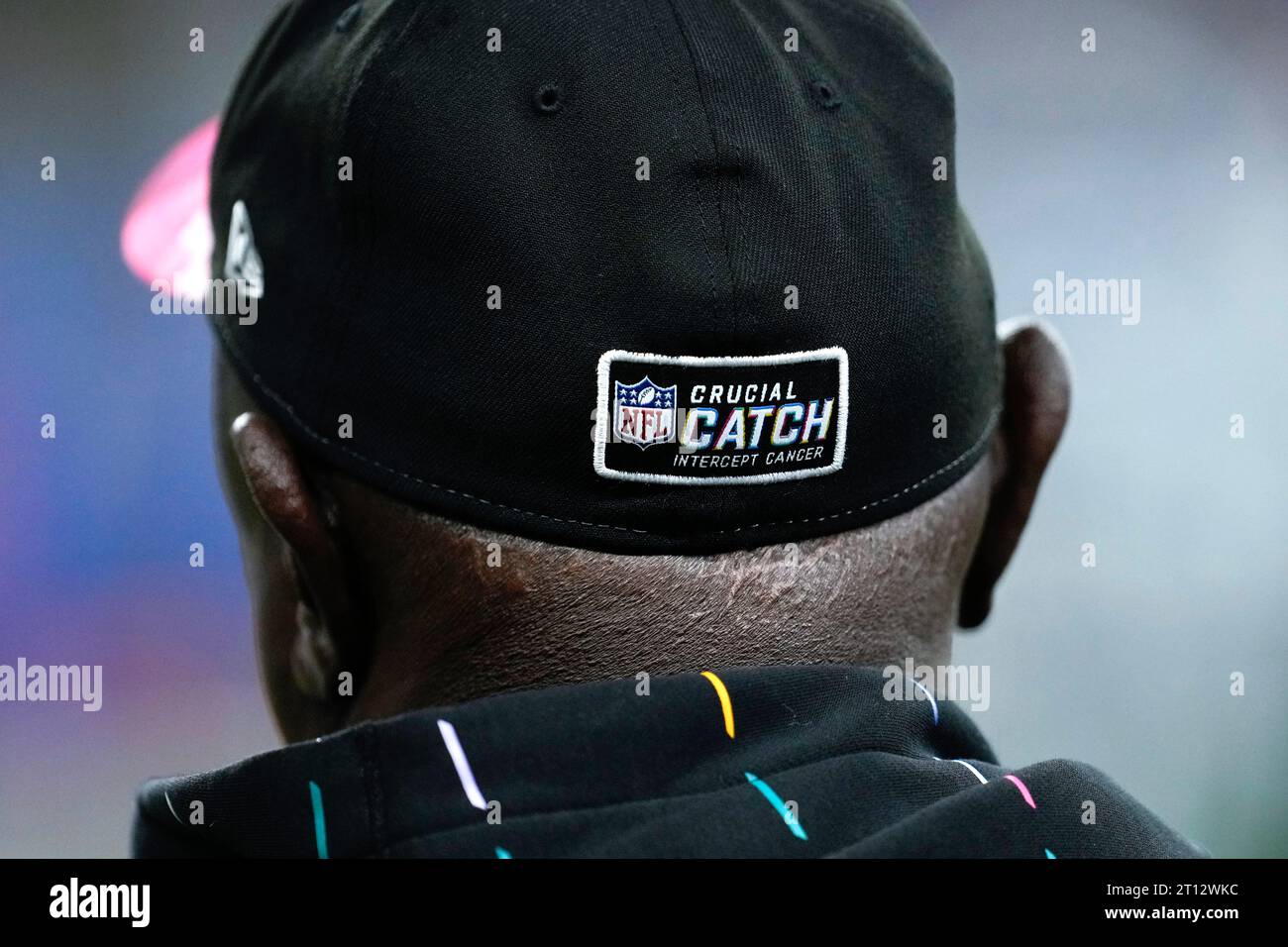 A Carolina Panthers staff member wears a hat with Crucial Catch ...