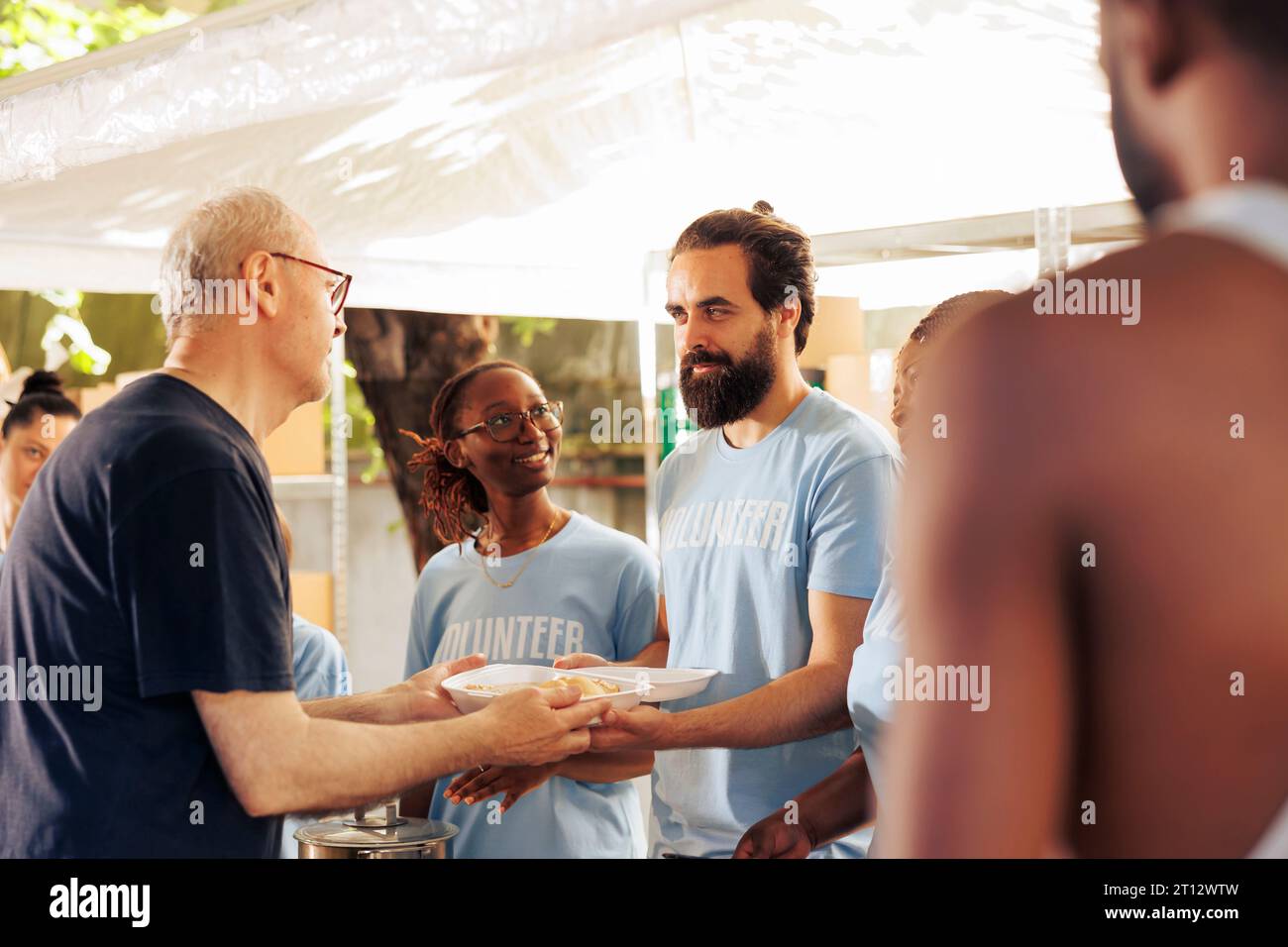 Members of a multicultural community come together, volunteering at non ...