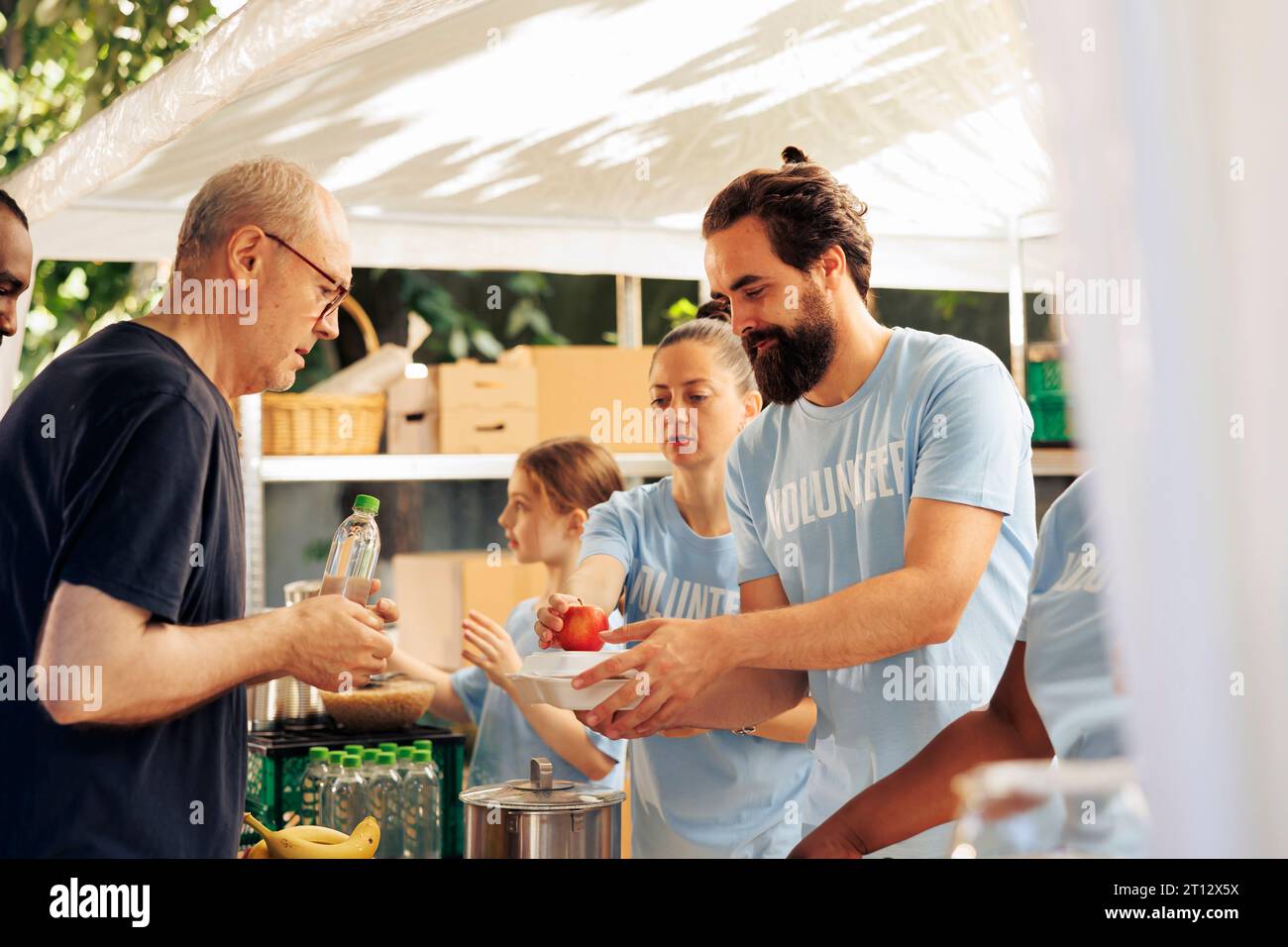 Friendly voluntary individuals helping the less fortunate, providing ...