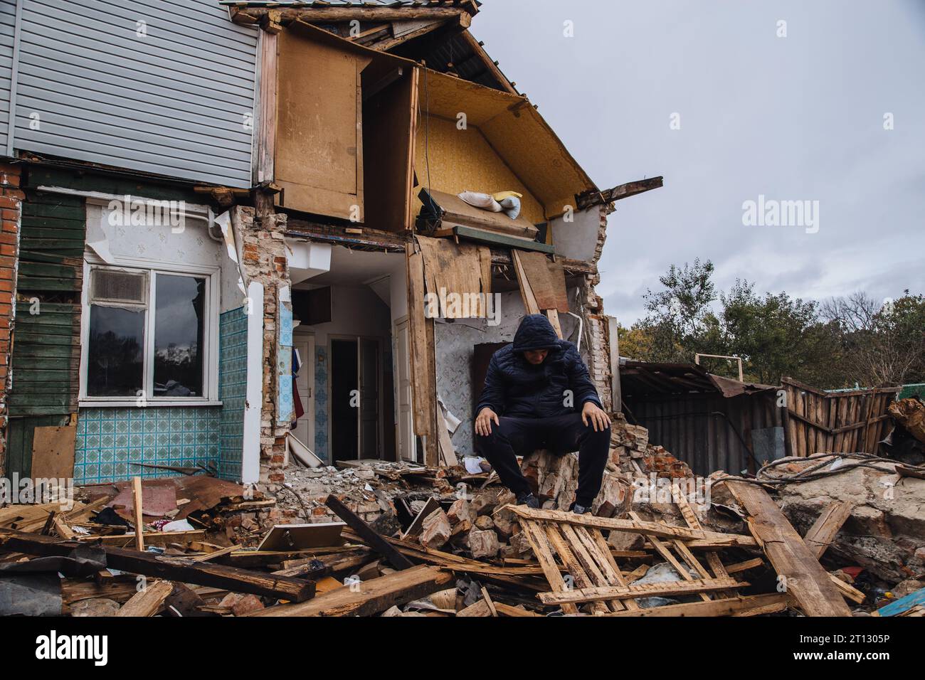 Sad man on ruined house. Hopeless, homelessness, result of military ...