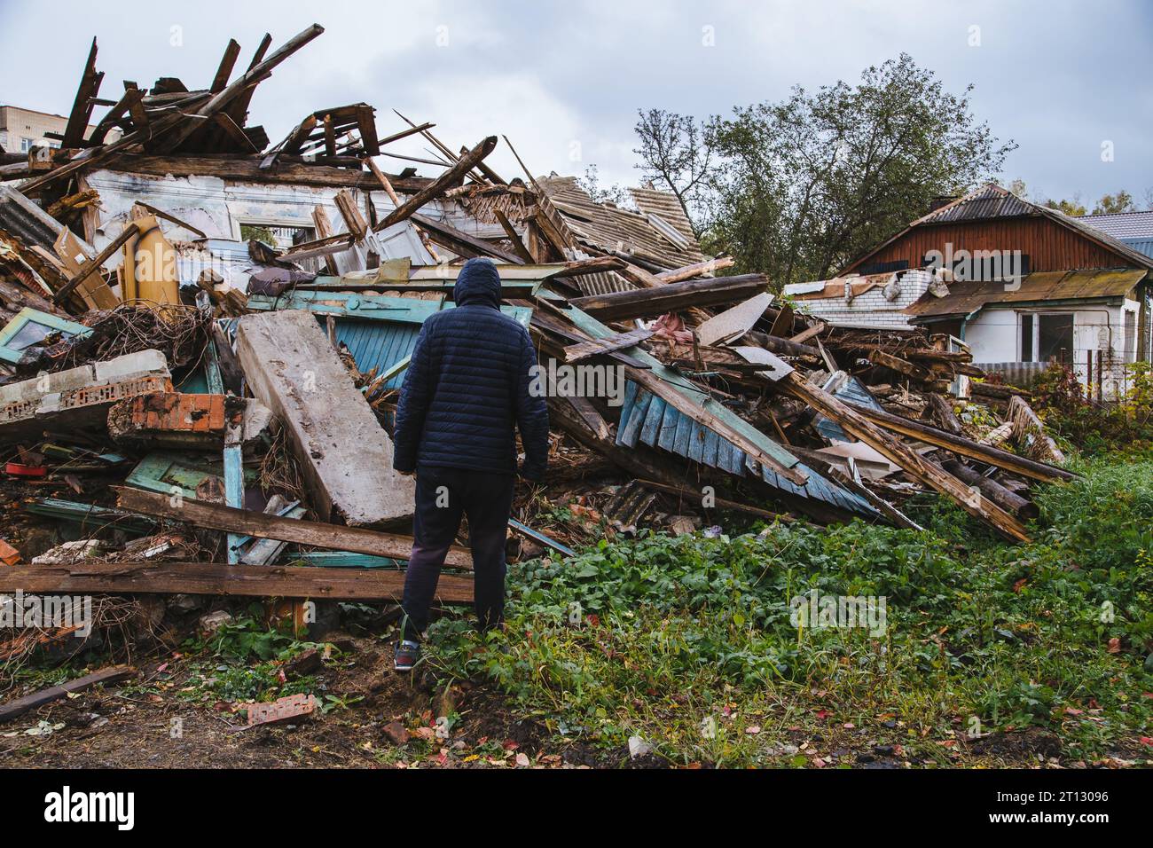 Sad man on ruined house. Hopeless, homelessness, result of military ...
