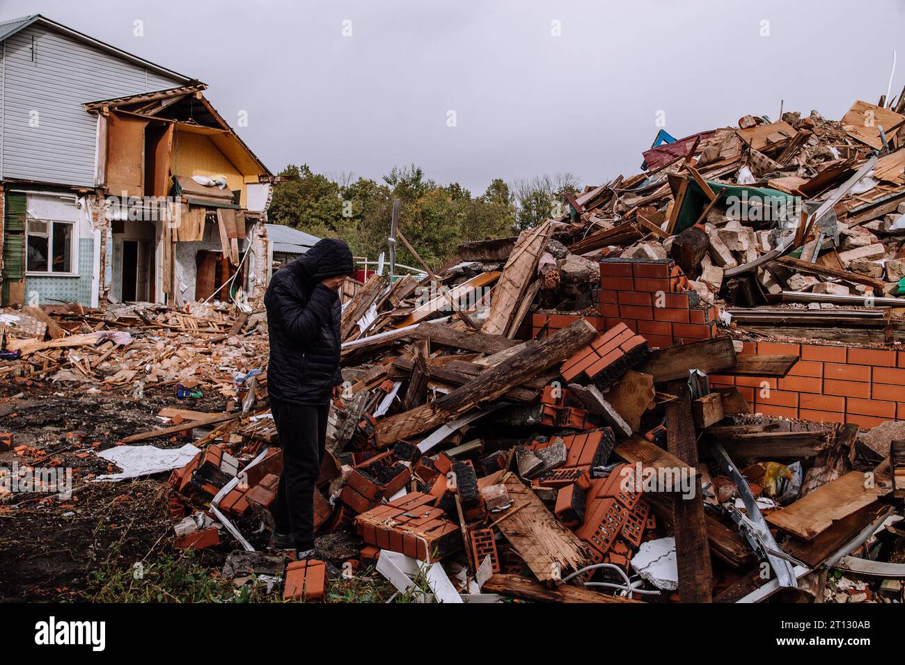 Sad man on ruined house. Hopeless, homelessness, result of military ...