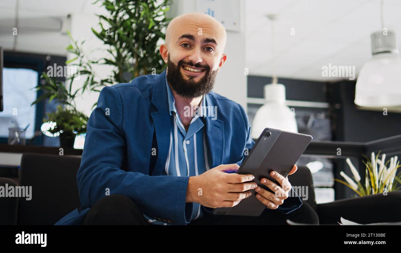 Startup worker using tablet in office, making presentation for ...