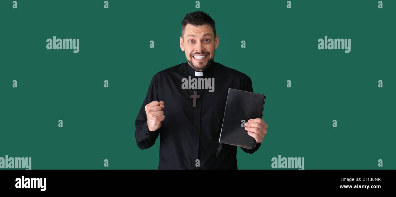 Happy priest with Bible on green background Stock Photo - Alamy