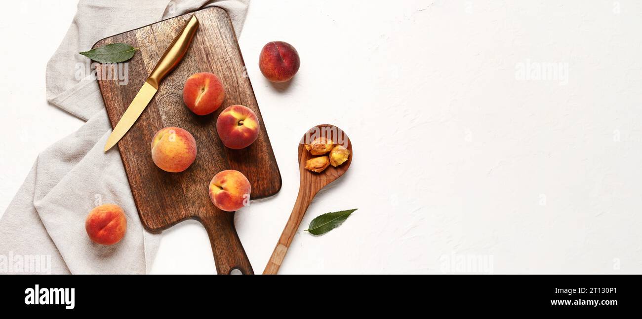 Sweet peaches, cutting board and knife on white background with space ...