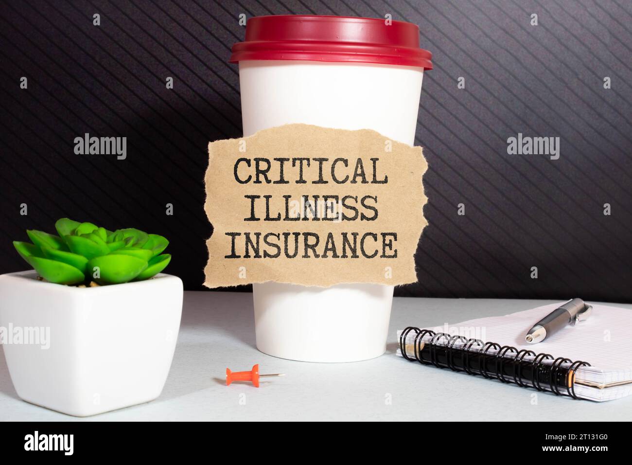 Notepad with text CRITICAL ILLNESS INSURANCE. Diagram and white ...
