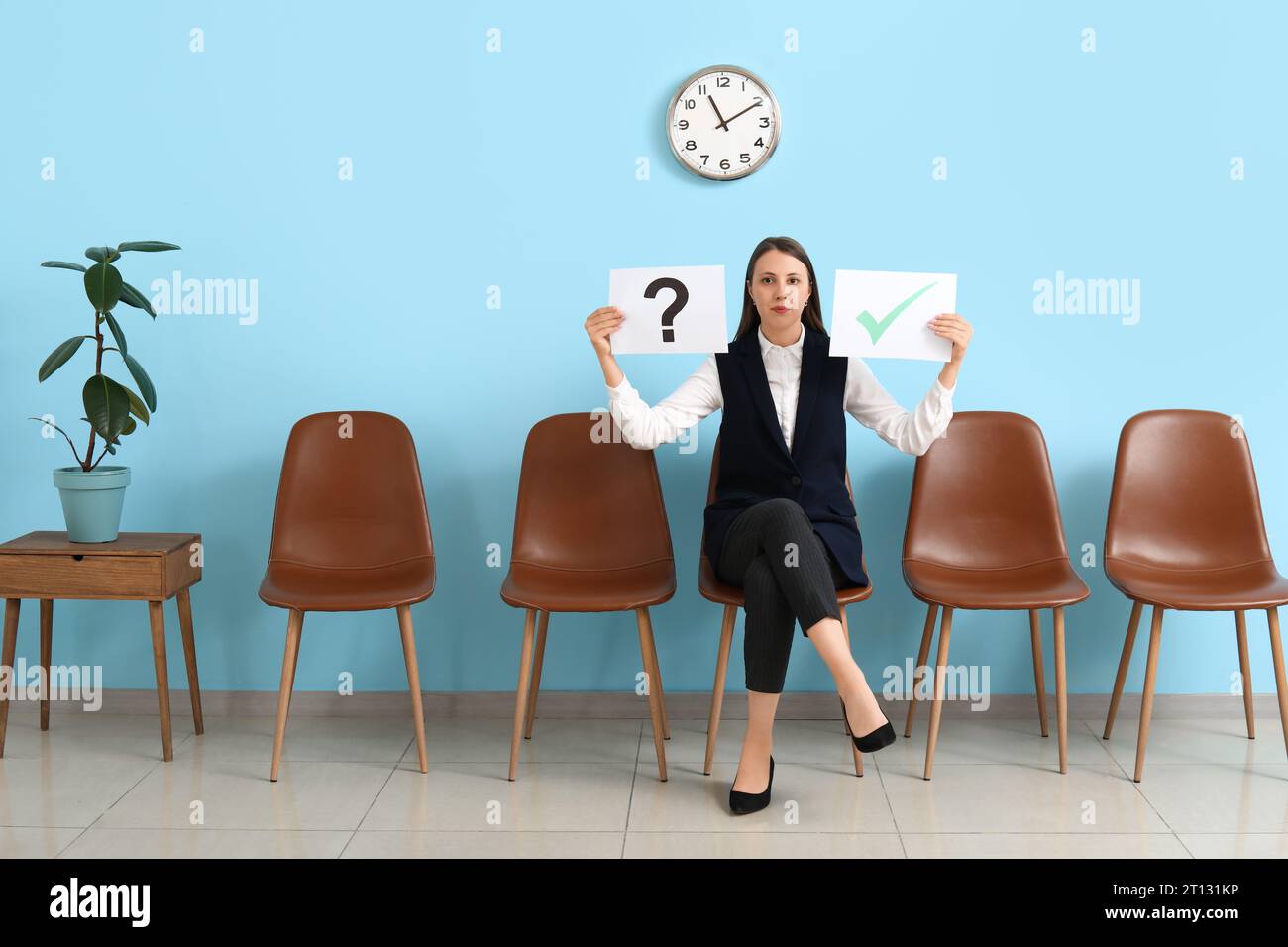 Female applicant holding paper sheets with question and check marks in ...