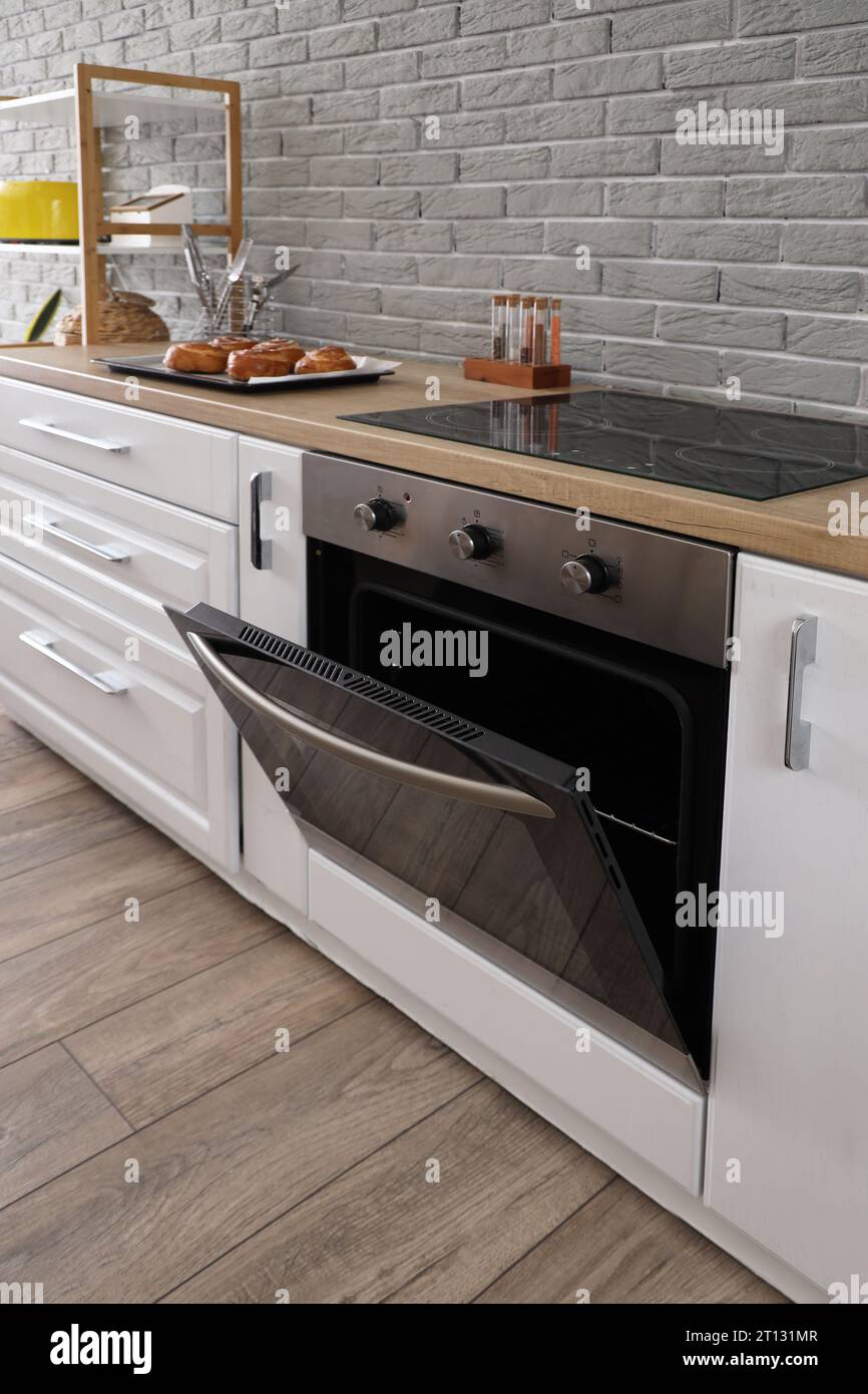 Opened electric oven with stove in interior of kitchen, closeup Stock ...