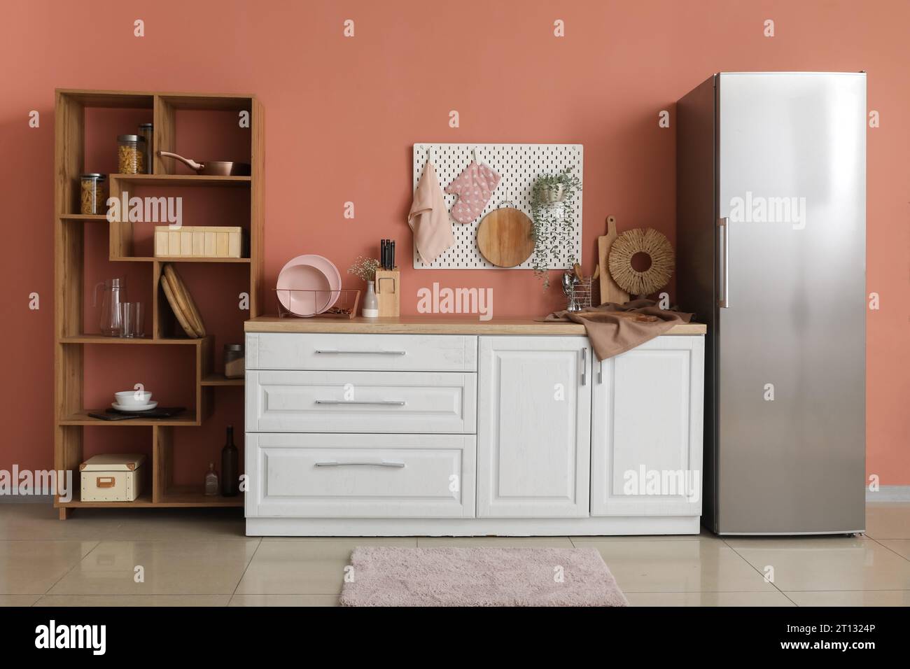 Interior of modern kitchen with white counters, pegboard, fridge and ...