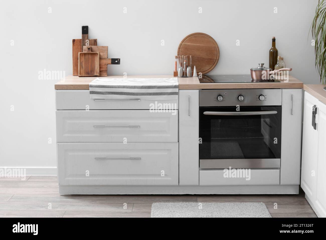 White kitchen counters with cutting boards, electric stove and oven ...
