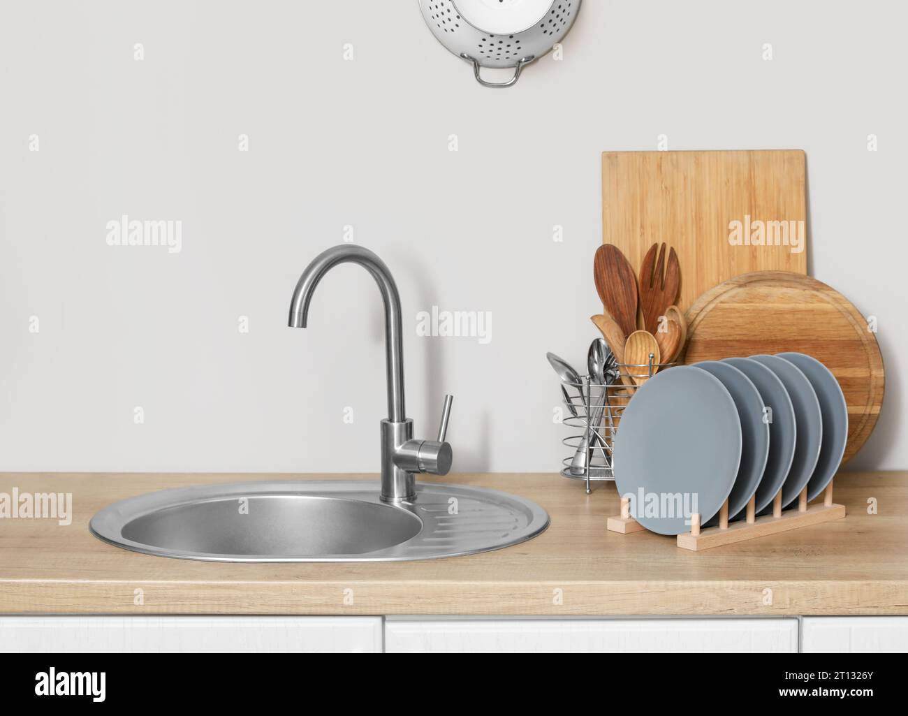 Kitchen counter with cutting boards, plate rack and utensils Stock ...