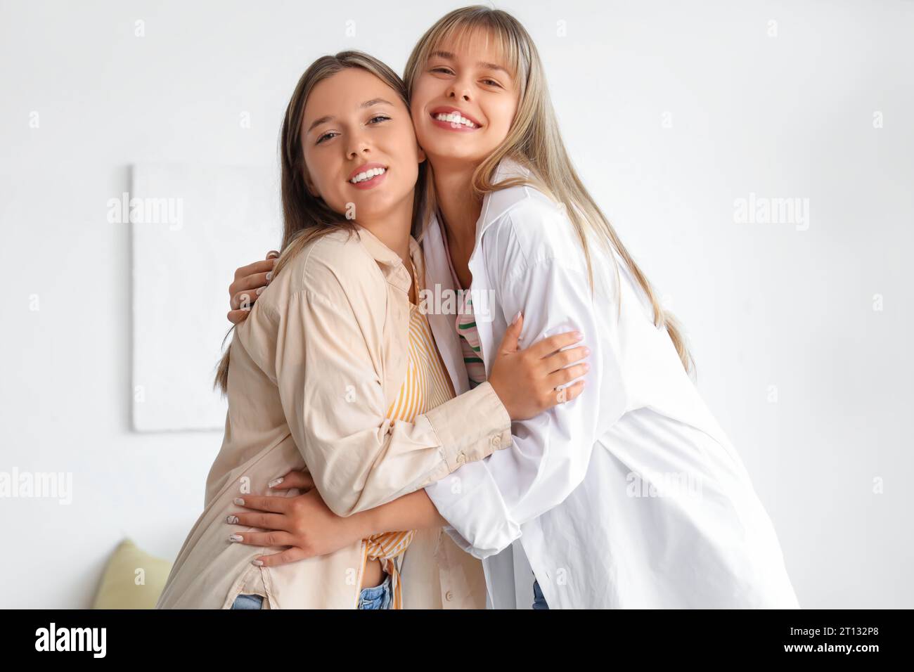 Female students hugging in dorm room Stock Photo - Alamy