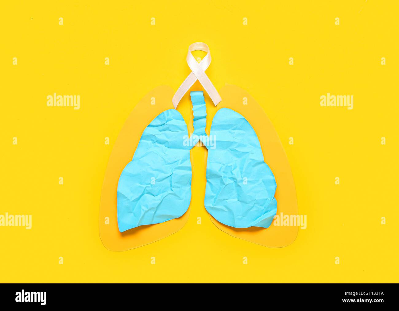 Crumpled paper lungs with white ribbon on yellow background. Lung ...