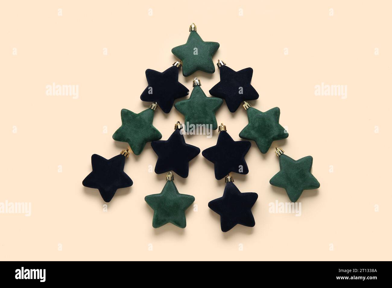 Christmas tree made of stars on beige background Stock Photo - Alamy