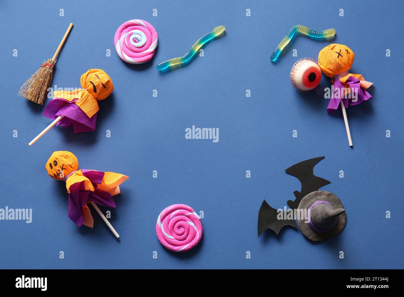 Frame made of sweet lollipops with witch hat, jelly worms and eye for ...