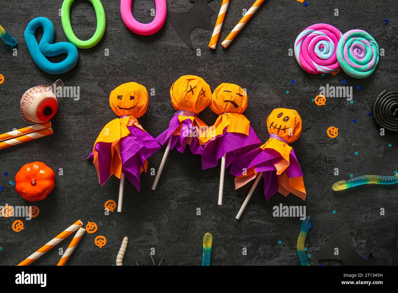 Word BOO made of candies with sweet lollipops, jelly worms and straws ...