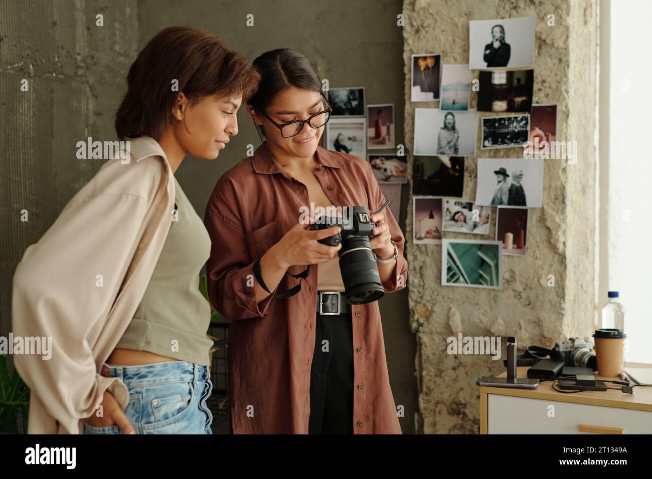 Young fashion model and photographer looking through new shots on ...