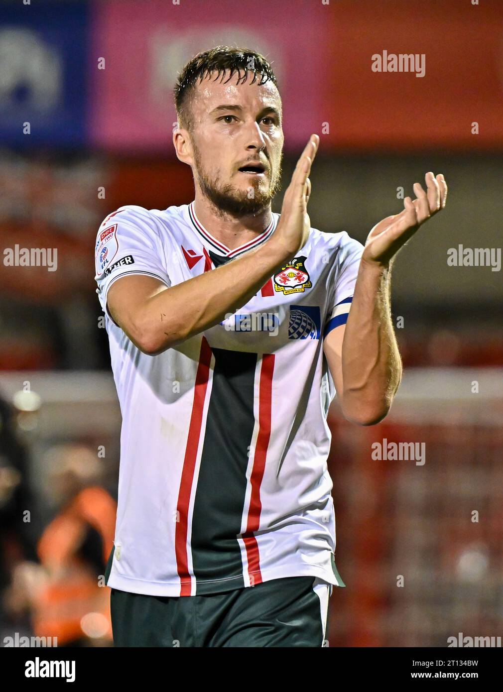 Luke Young 8# of Wrexham Association Football Club claps fans at full ...