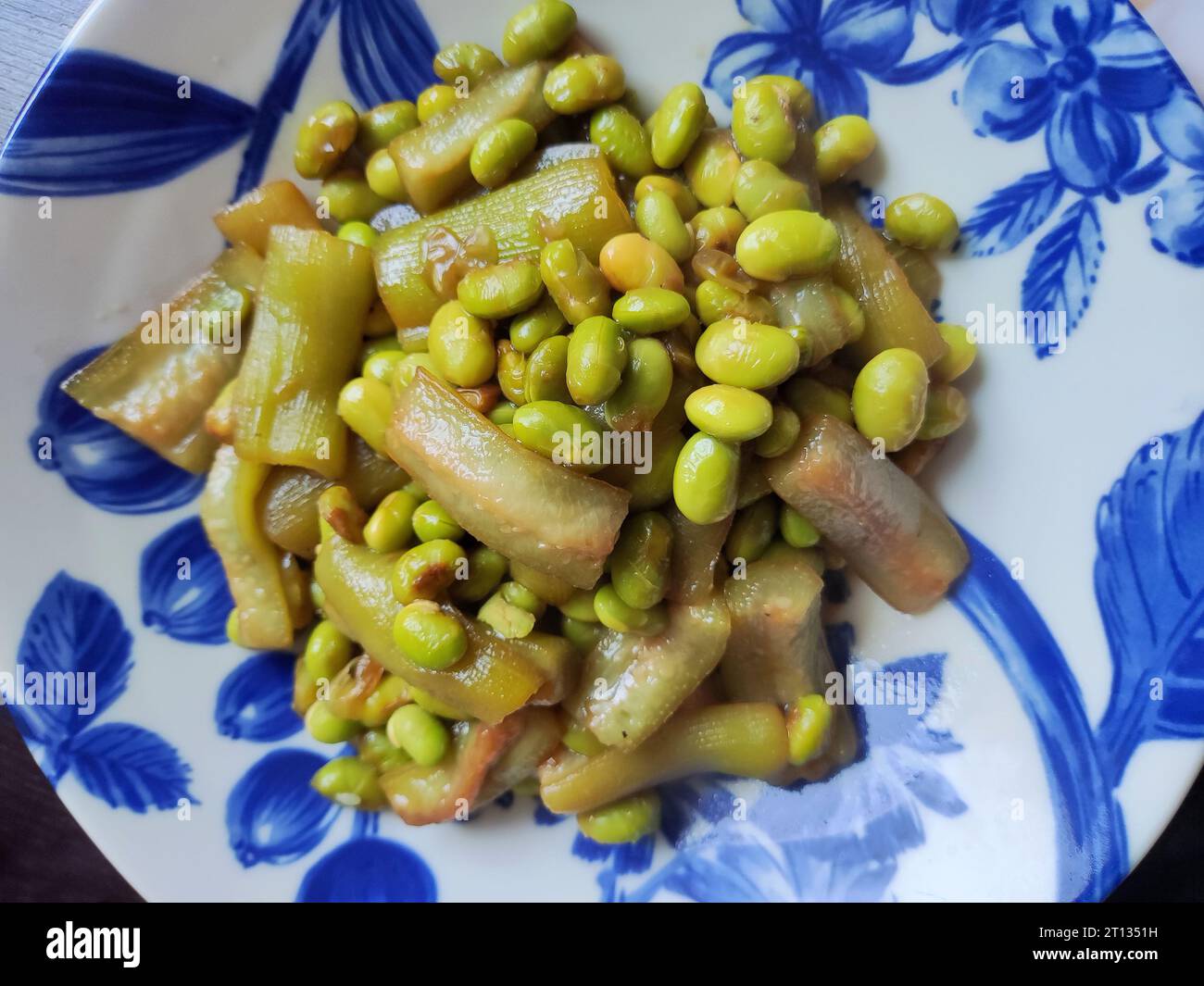 Luffa aegyptiaca braised with green soybeans in the blue plate for ...