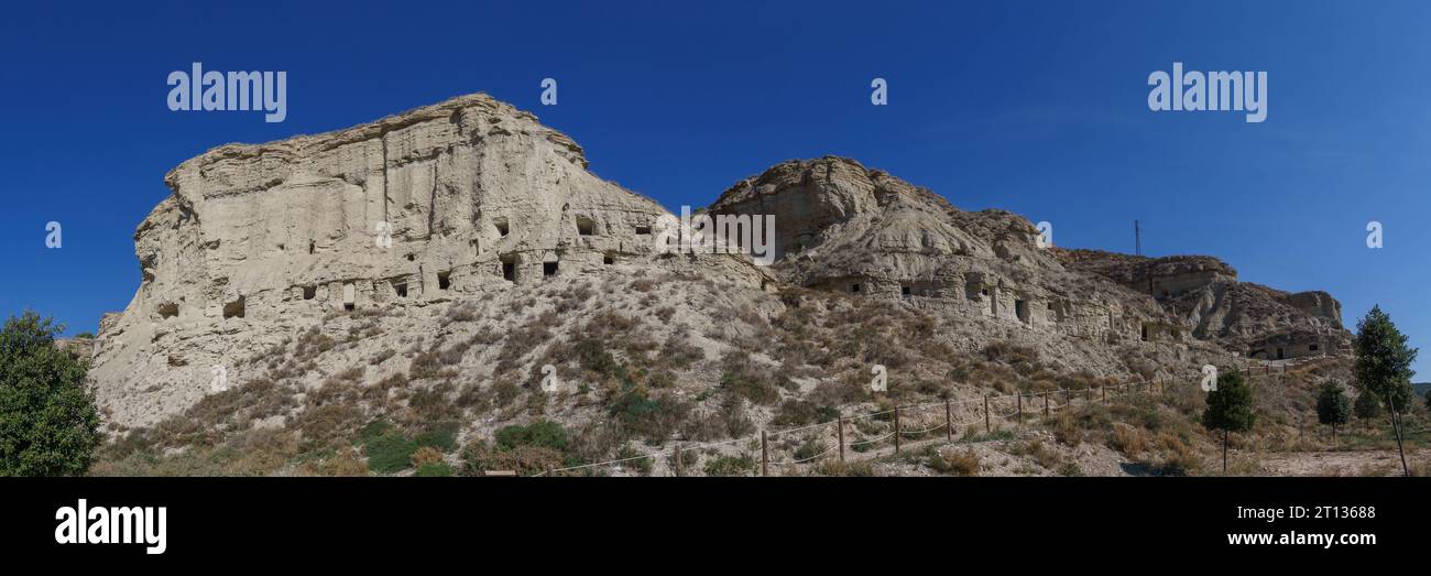 Panorama picture of human made caves inside the rock of a hill in ...