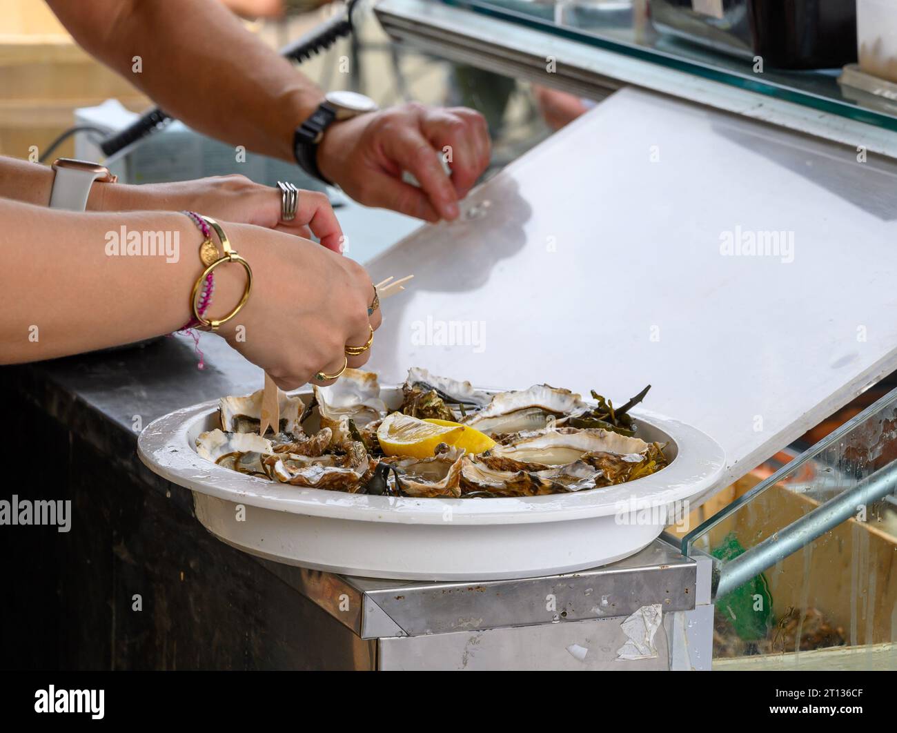 Shucking of fresh french Gillardeau oysters molluscs on oysters ...