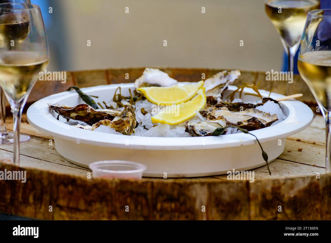 Fresh french Gillardeau oysters molluscs shucked on ice with lemon with ...