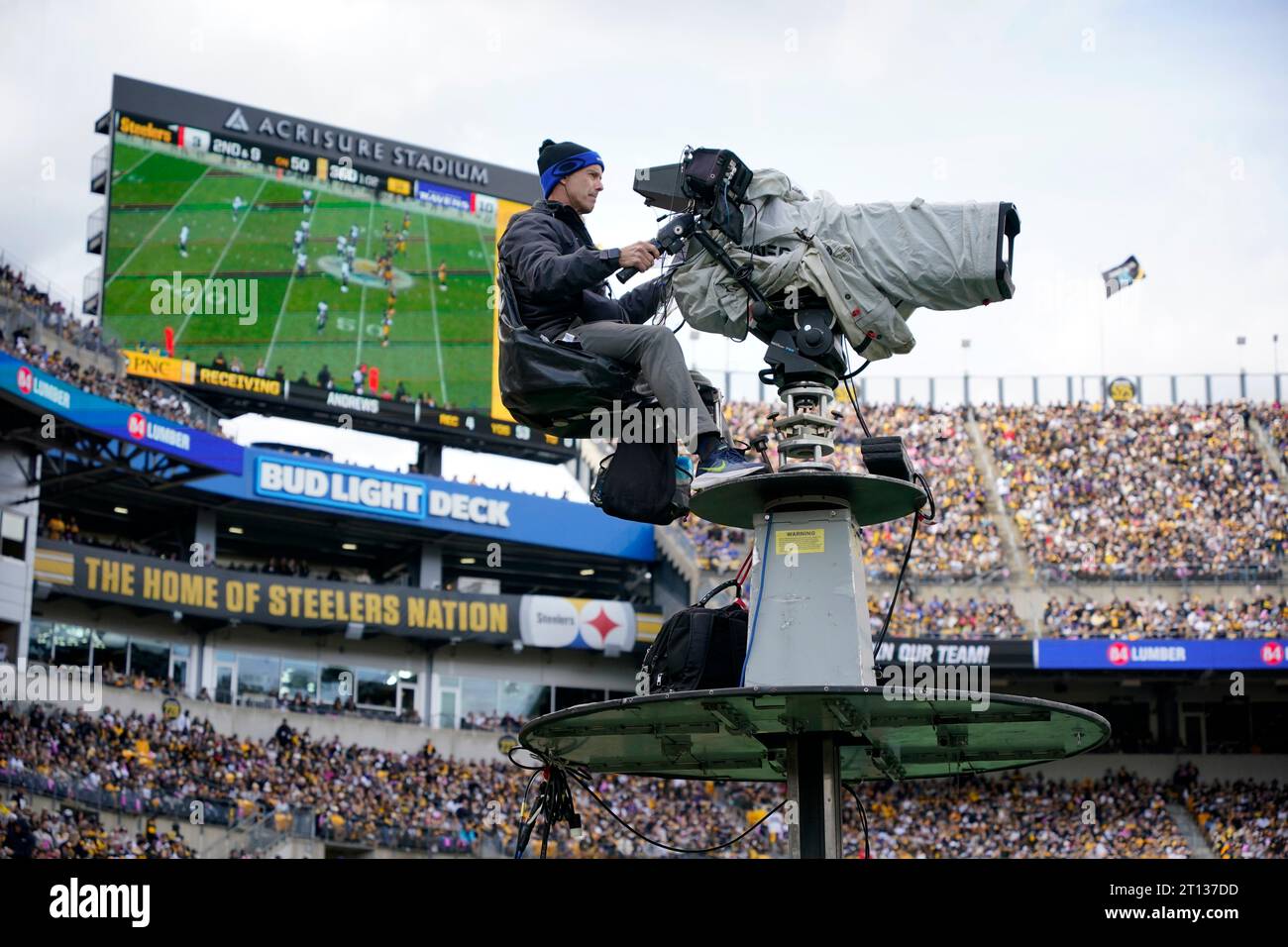 A CBS cameraman works an NFL football game between the Pittsburgh ...
