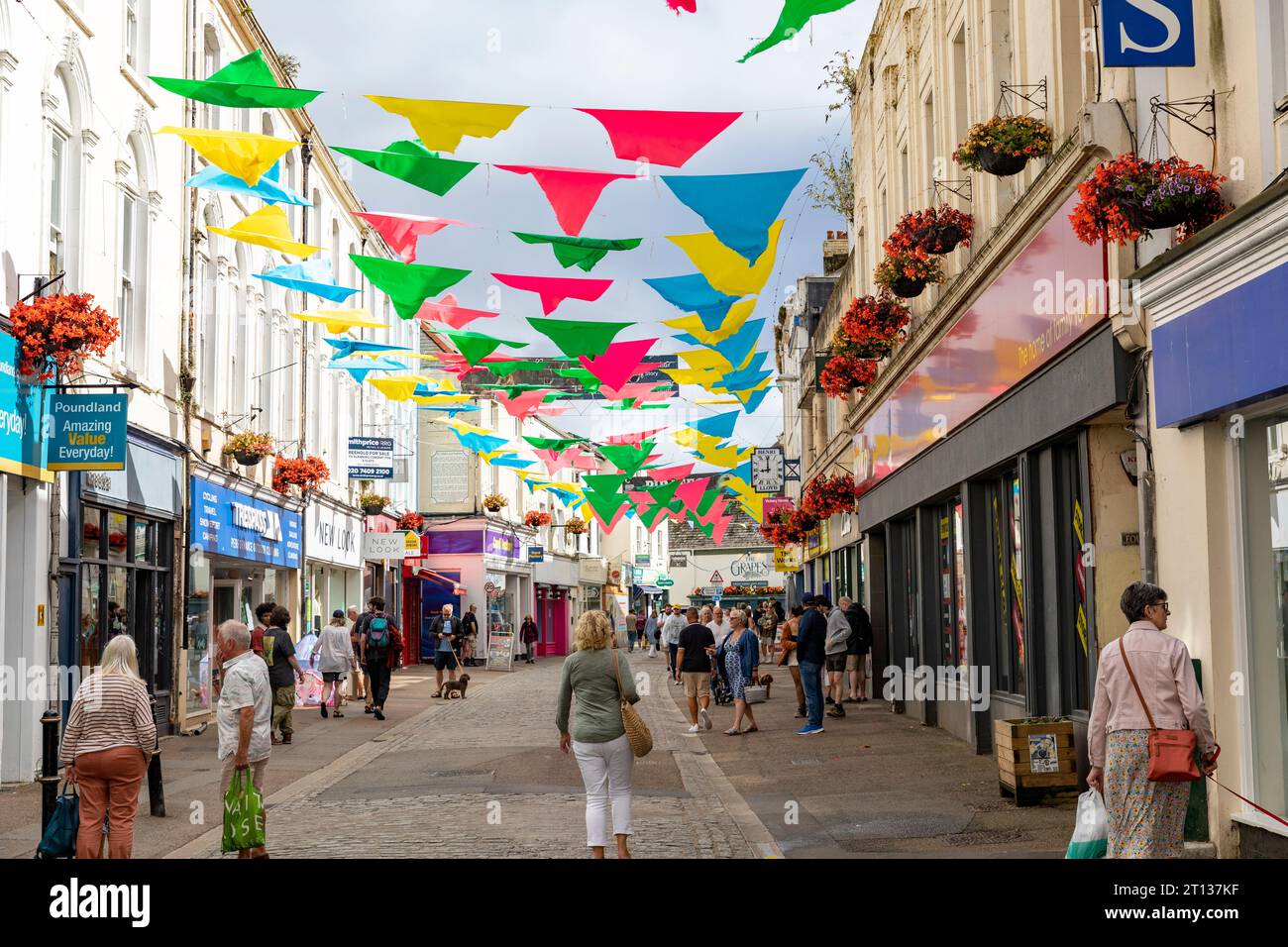 Falmouth town centre Cornwall, colourful street bunting above shoppers ...