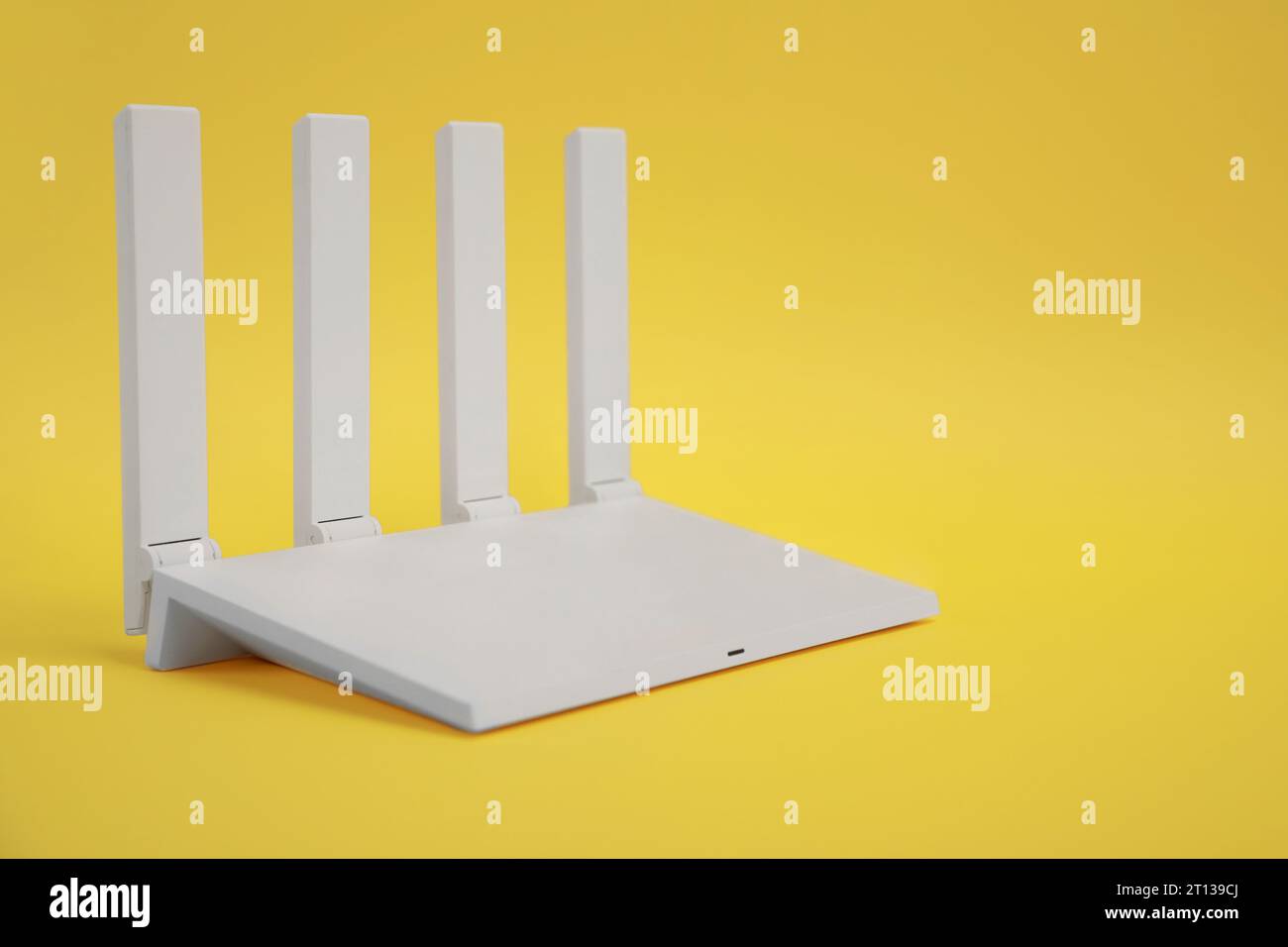 Modern Wi-Fi router on yellow background. Space for text Stock Photo ...