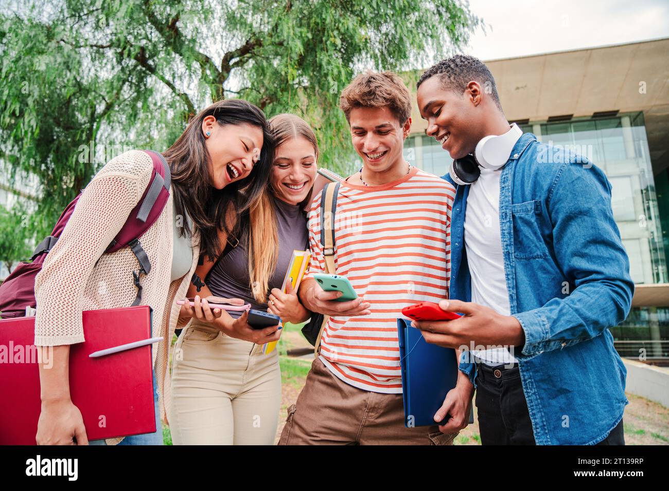 Group of students having fun together sharing on the social media with ...