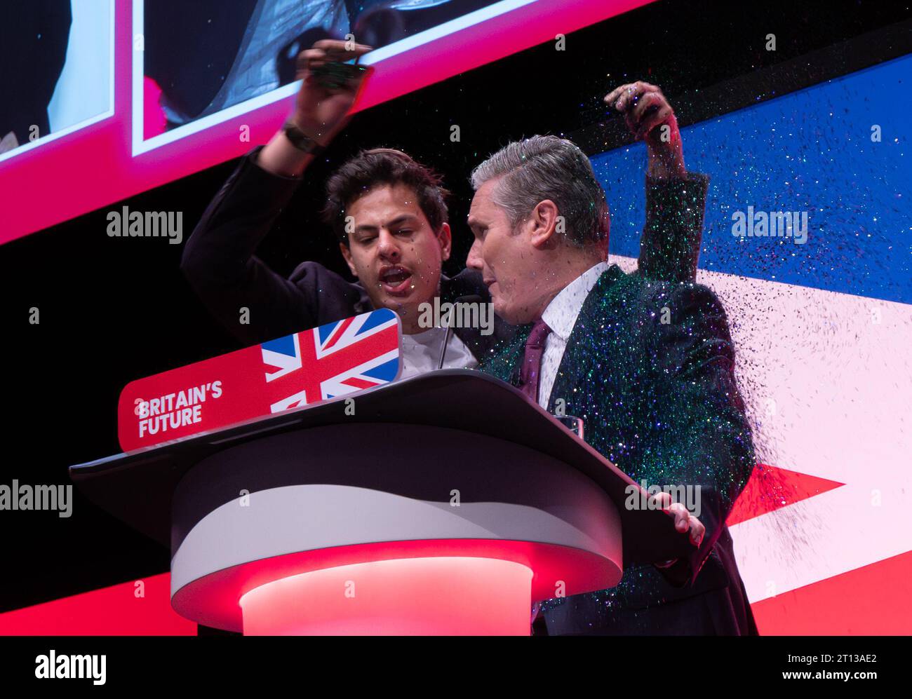 Protester, Yaz Ashmawi, covers Keir Starmer with glitter during the ...