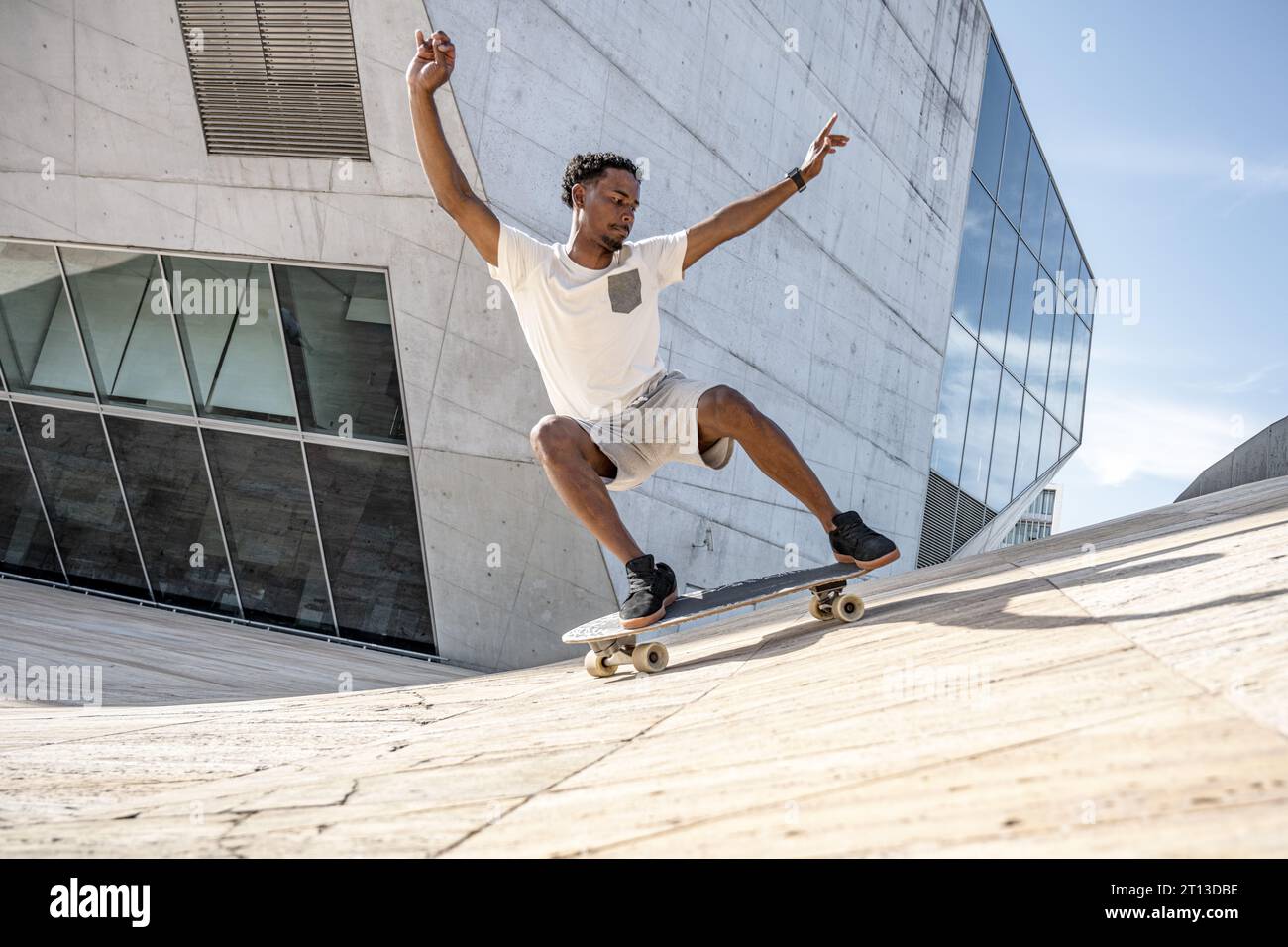 Surf skater training surfing moves on a urban scene Stock Photo - Alamy