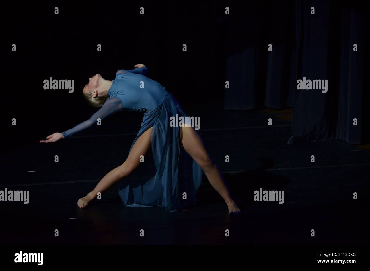 dancer striking a pose in the spotlight Stock Photo - Alamy