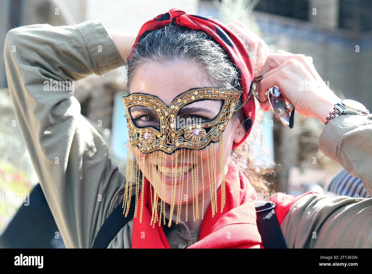 Tehran, Iran. 10th Oct, 2023. A woman tries a mask during a traditional ...
