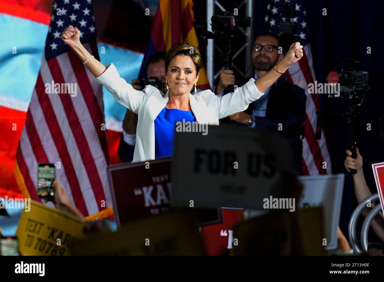 Republican candidate Kari Lake raises her arms to supporters as she ...