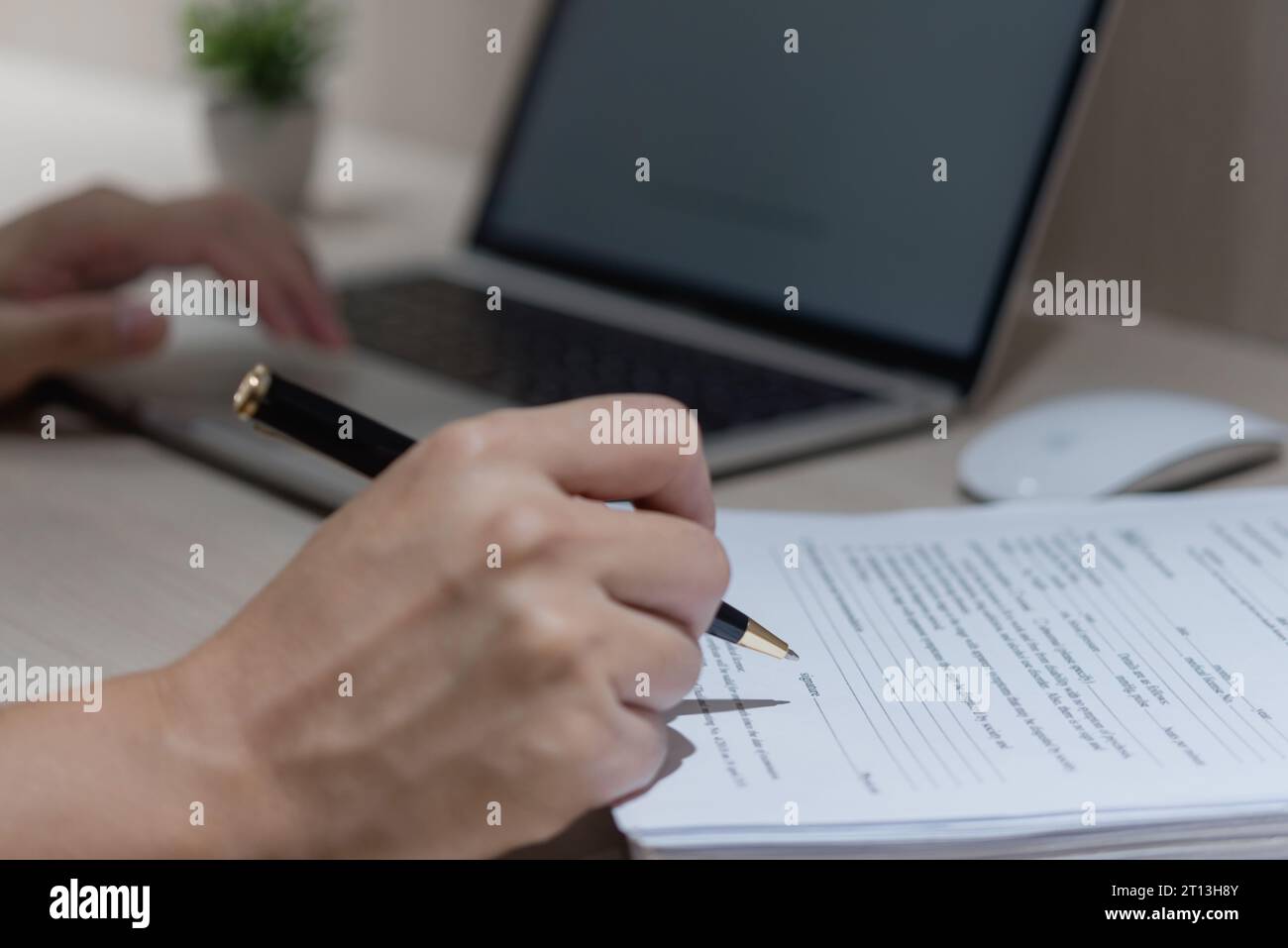 Hand using writing pen with paperwork in business company personal ...