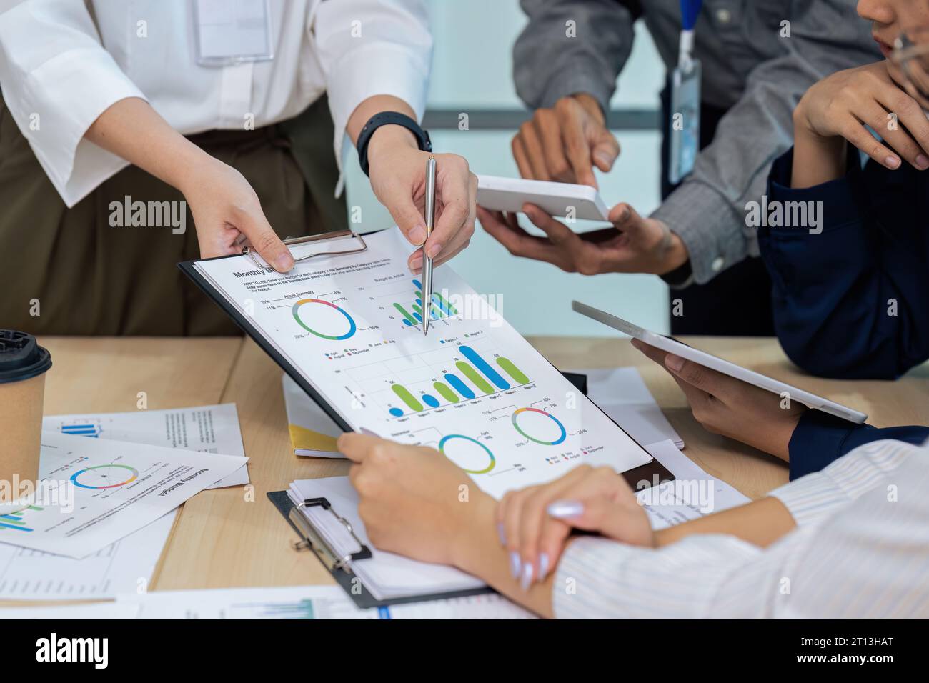 Business people teamwork with analysis cost graph on desk at meeting ...