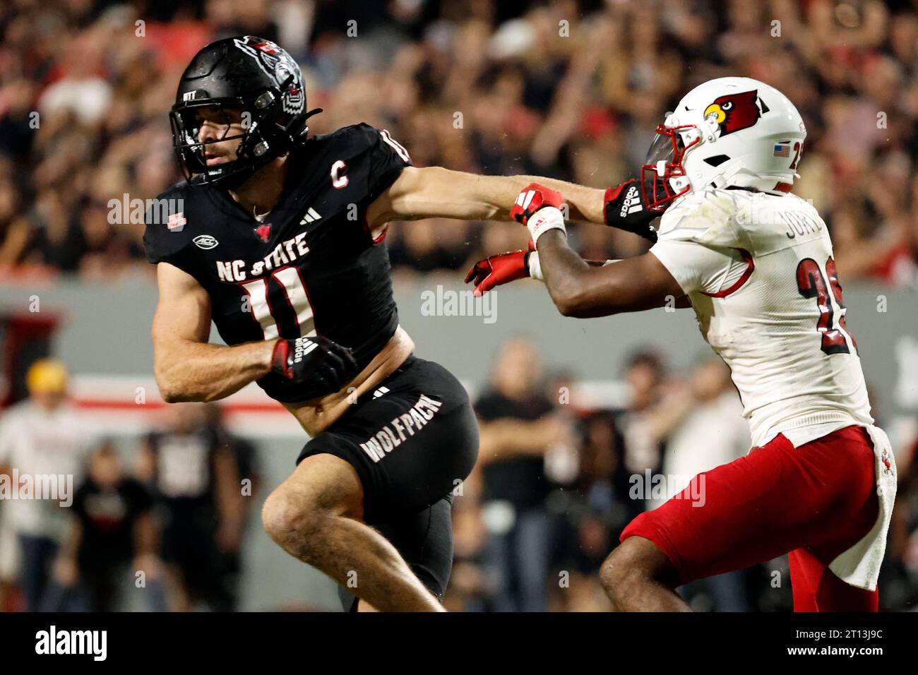 North Carolina State linebacker Payton Wilson (11) stiff arms ...