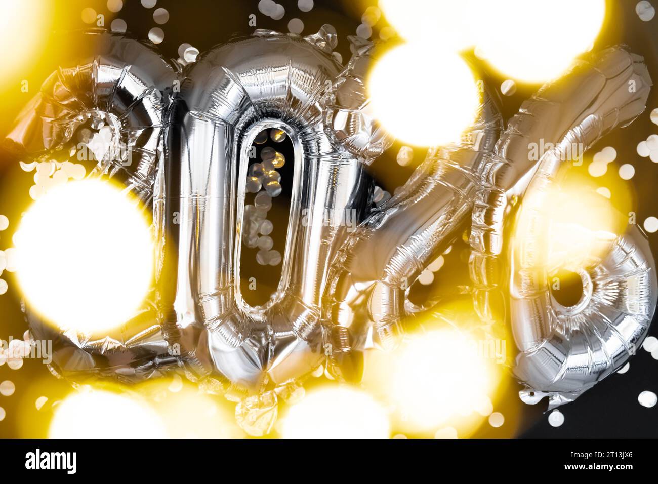 Holiday bokeh garland Happy new year 2026 metallic balloons with confetti on dark black ...