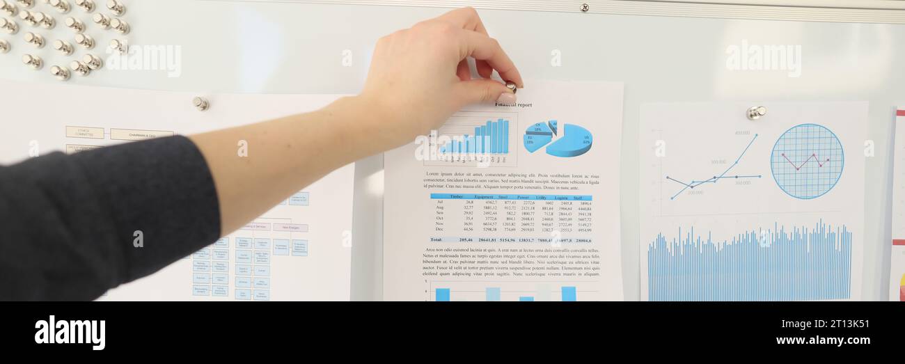 Hands of woman placing paper sheet with infographic charts Stock Photo ...