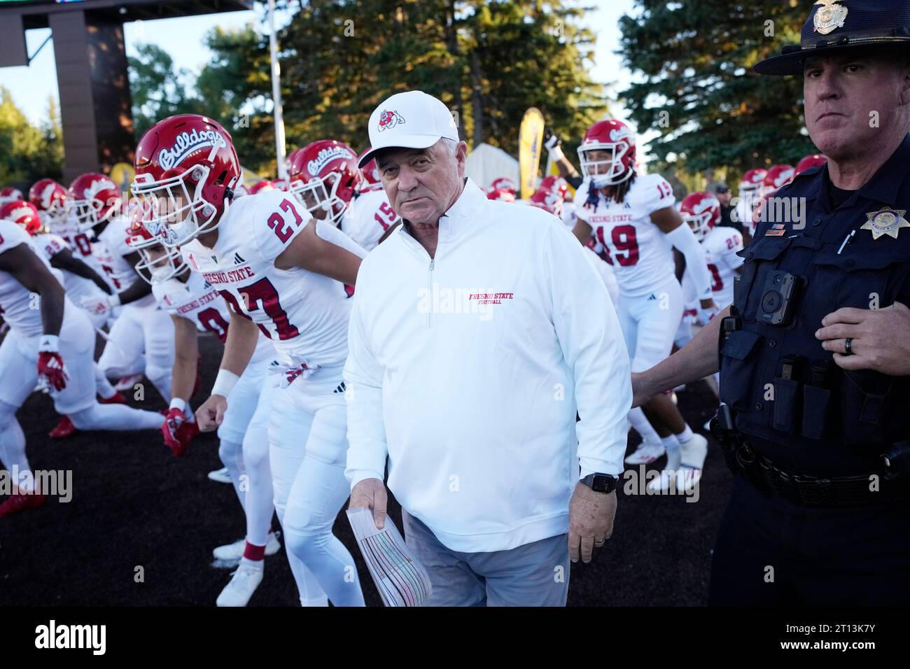 Fresno State head coach Jeff Tedford leads his players on to the field ...