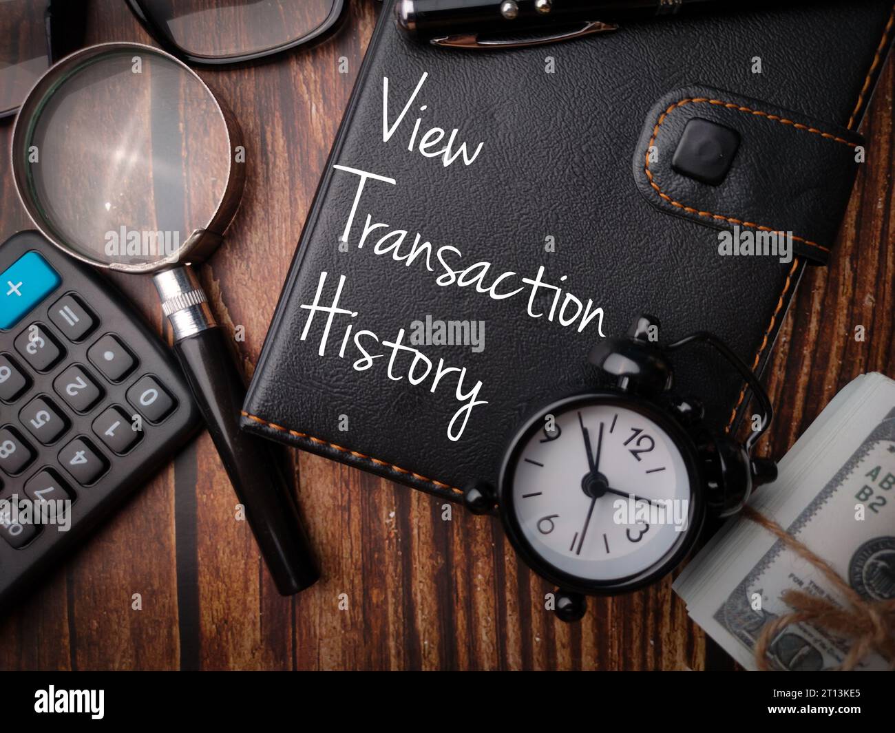 Top view magnifying glass,banknotes and calculator with the word View ...