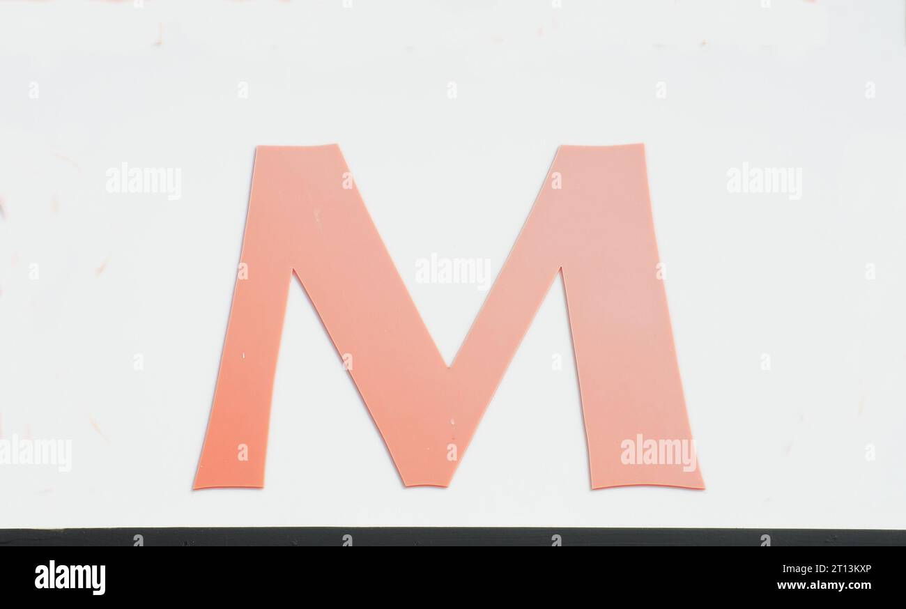 Faded letter M showing all its character of age, wear & usefulness ...